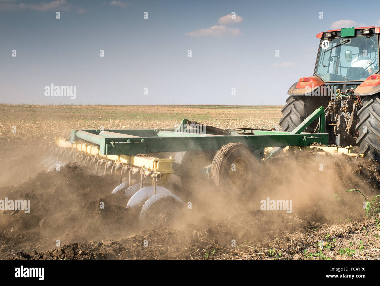 Tractor preparing land for sowing Stock Photo - Alamy