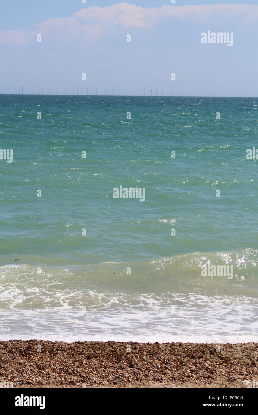 Tide coming in over a pebbled beach Stock Photo - Alamy