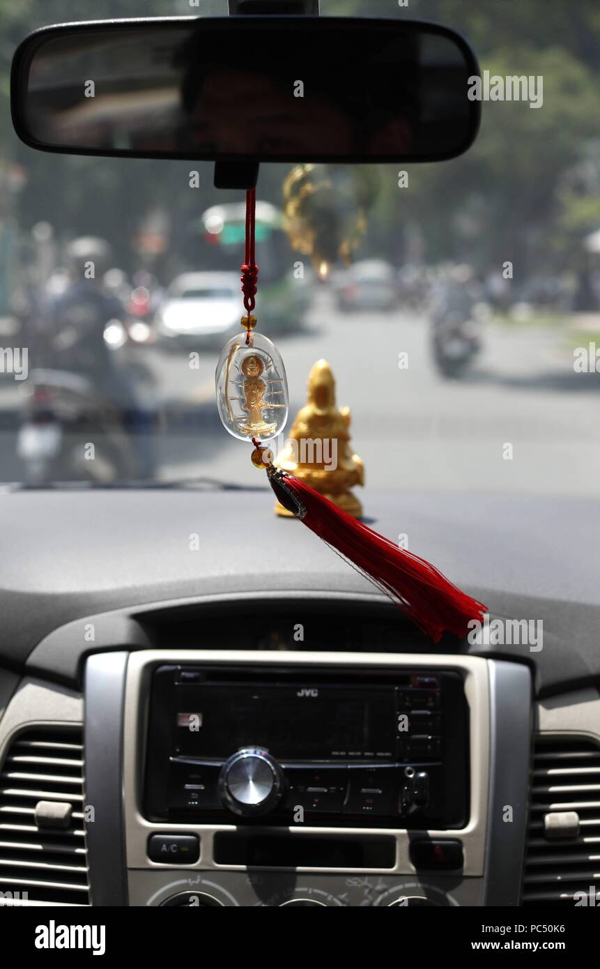 Buddhist amulets inside car for protection. Ho Chi Minh city. Vietnam ...