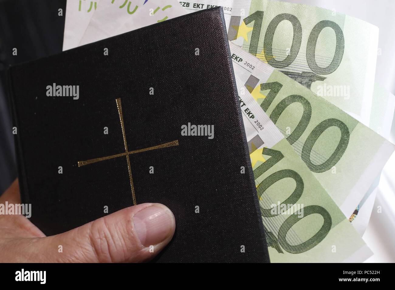 Money and religion. Holy bible and euros. | usage worldwide Stock Photo ...