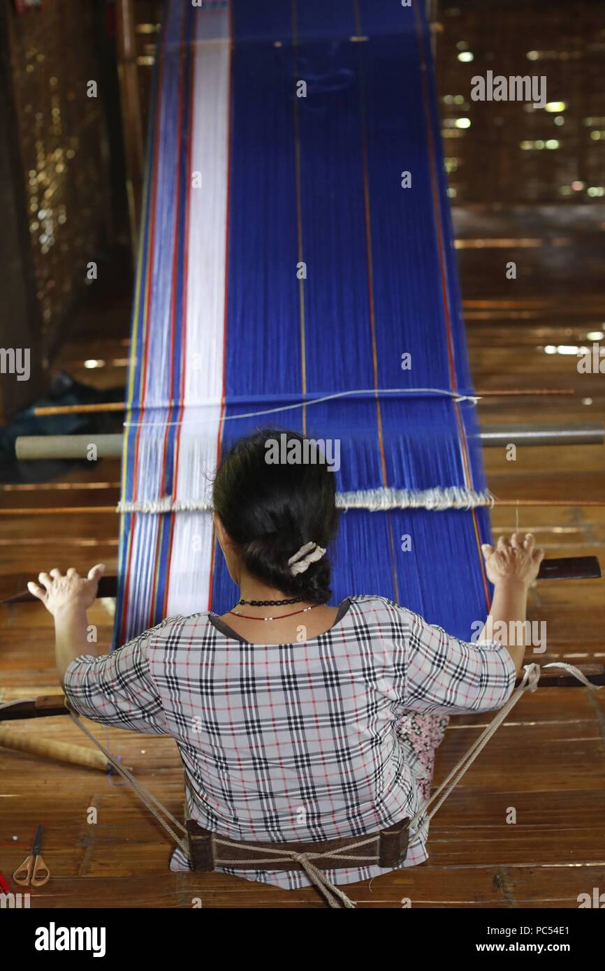 Bahnar (Ba Na) ethnic group. Woman weaving silk at wooden loom. Kon Tum ...