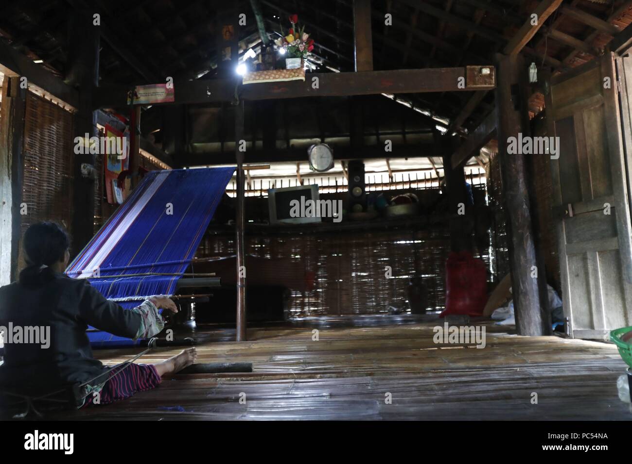 Bahnar (Ba Na) ethnic group. Woman weaving silk at wooden loom. Kon Tum ...