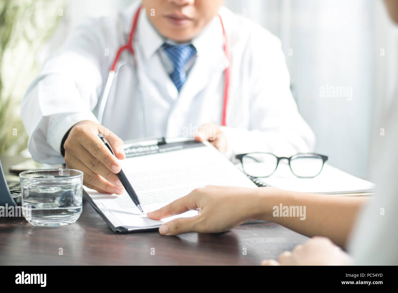 Doctor introduces patient signing on medical records before treat ...