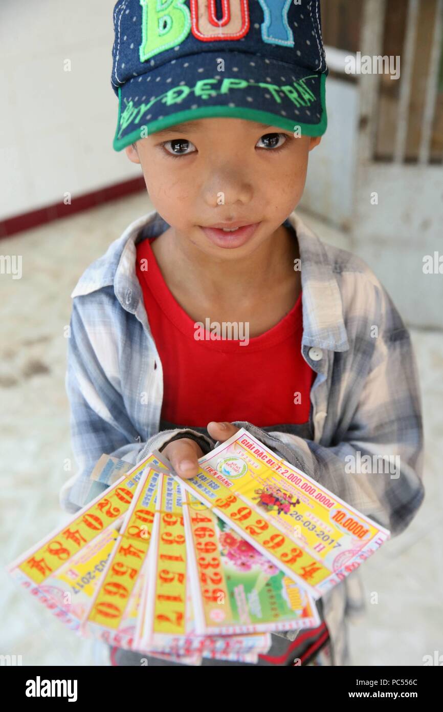 Young boy selling lottery tickets on the street. Thay Ninh. Vietnam ...