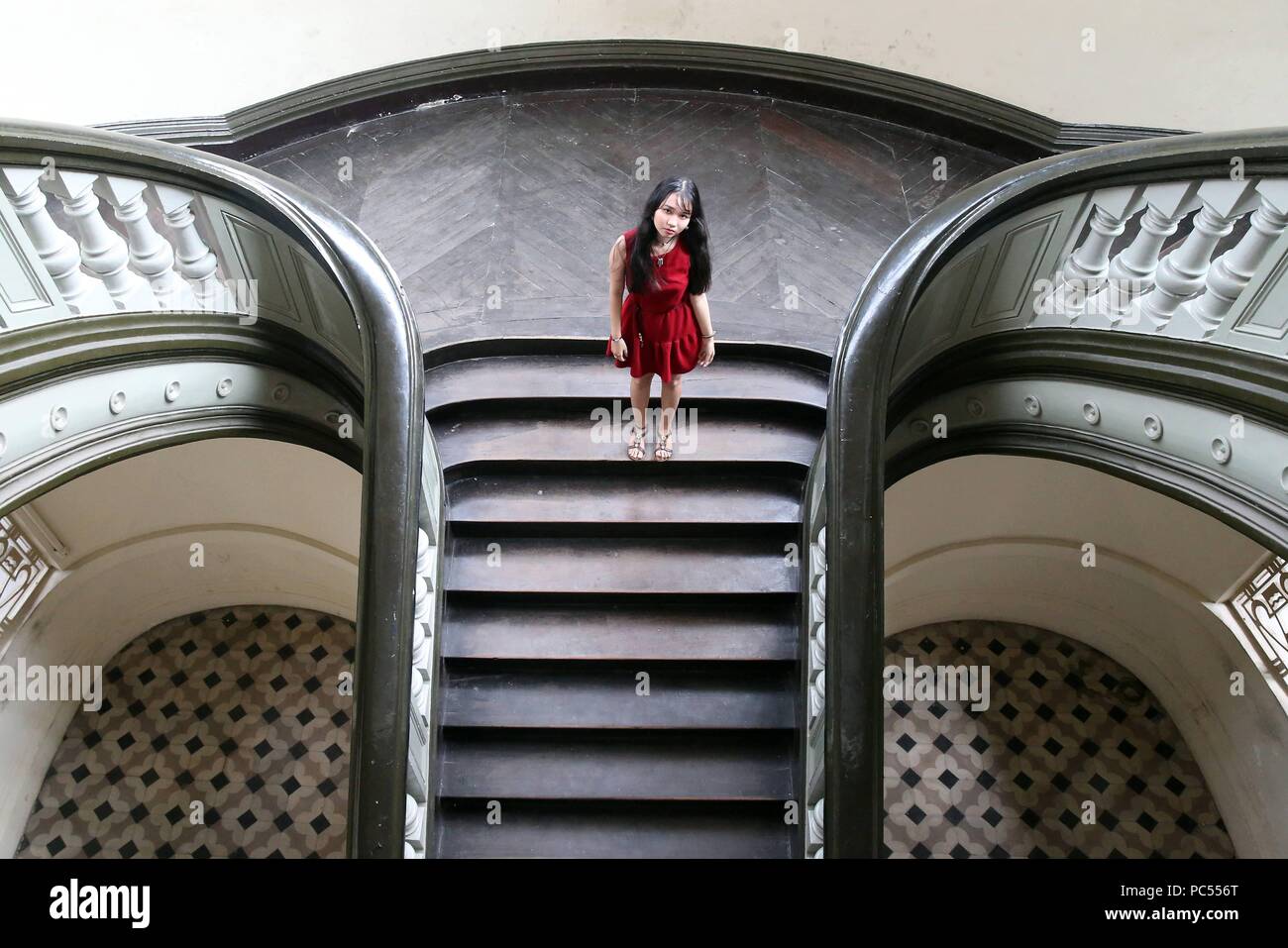 Young vietnamese girl on old staircase. Ho Chi Minh City. Vietnam ...