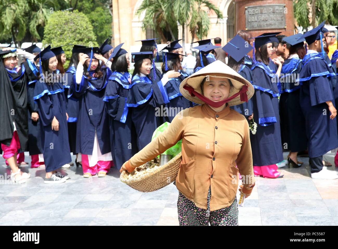 Group of Young Asian university students wearing cap and gown. Ho Chi ...