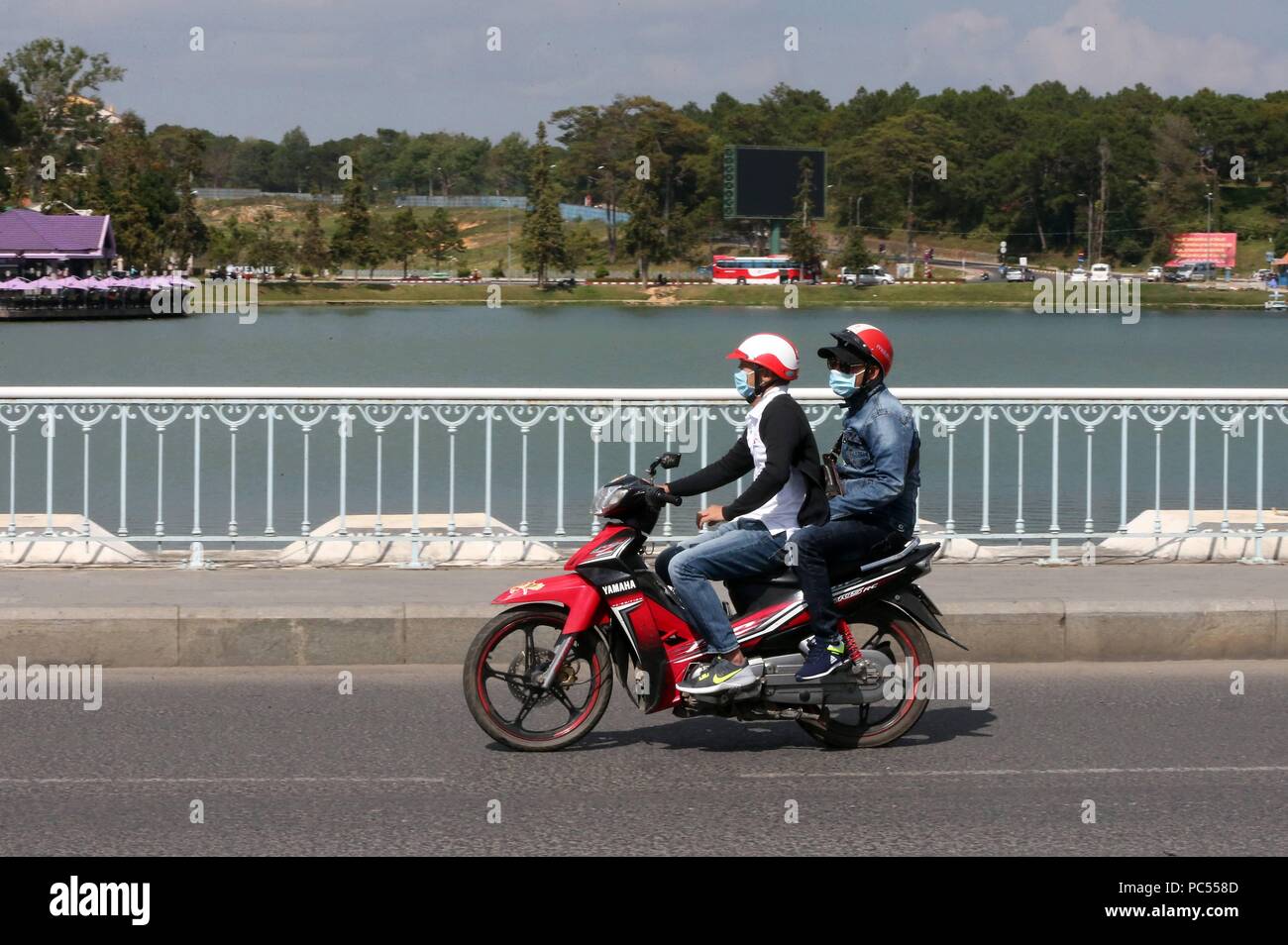 Young asian couple riding motorcycle. Dalat. Vietnam. | usage worldwide ...
