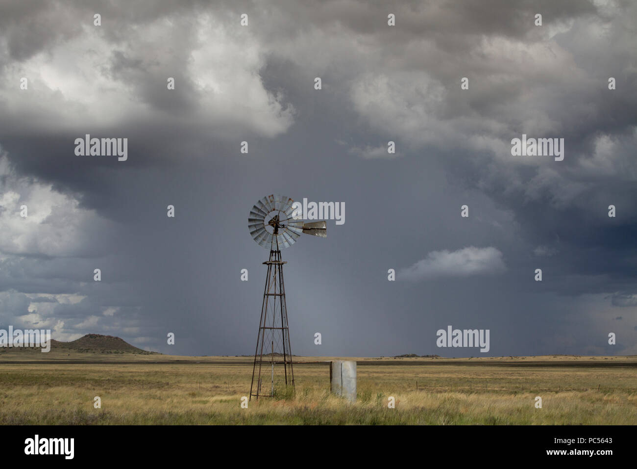Windmill with rain clouds Stock Photo - Alamy