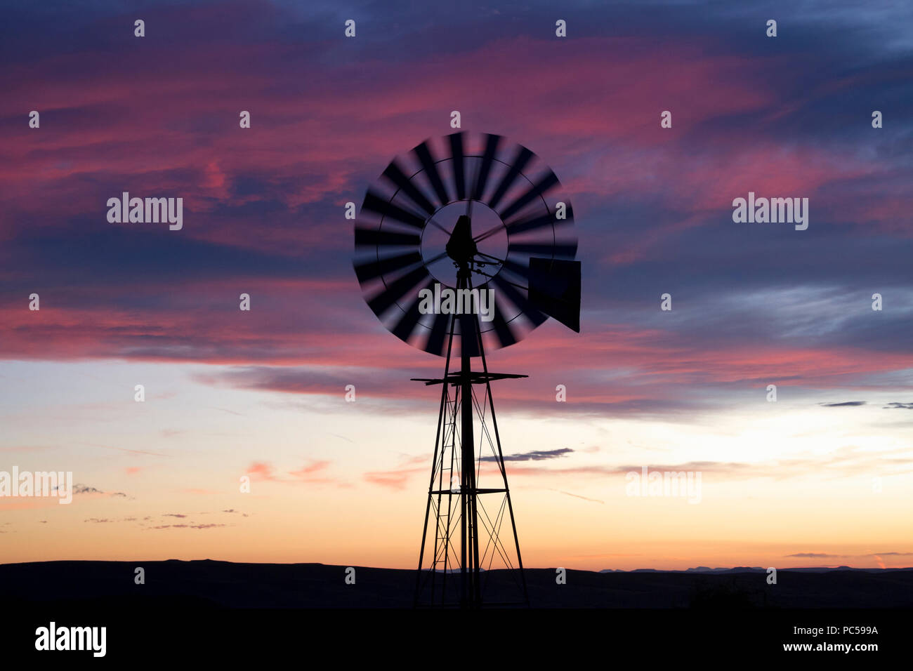 Windmill with sunset clouds Stock Photo - Alamy
