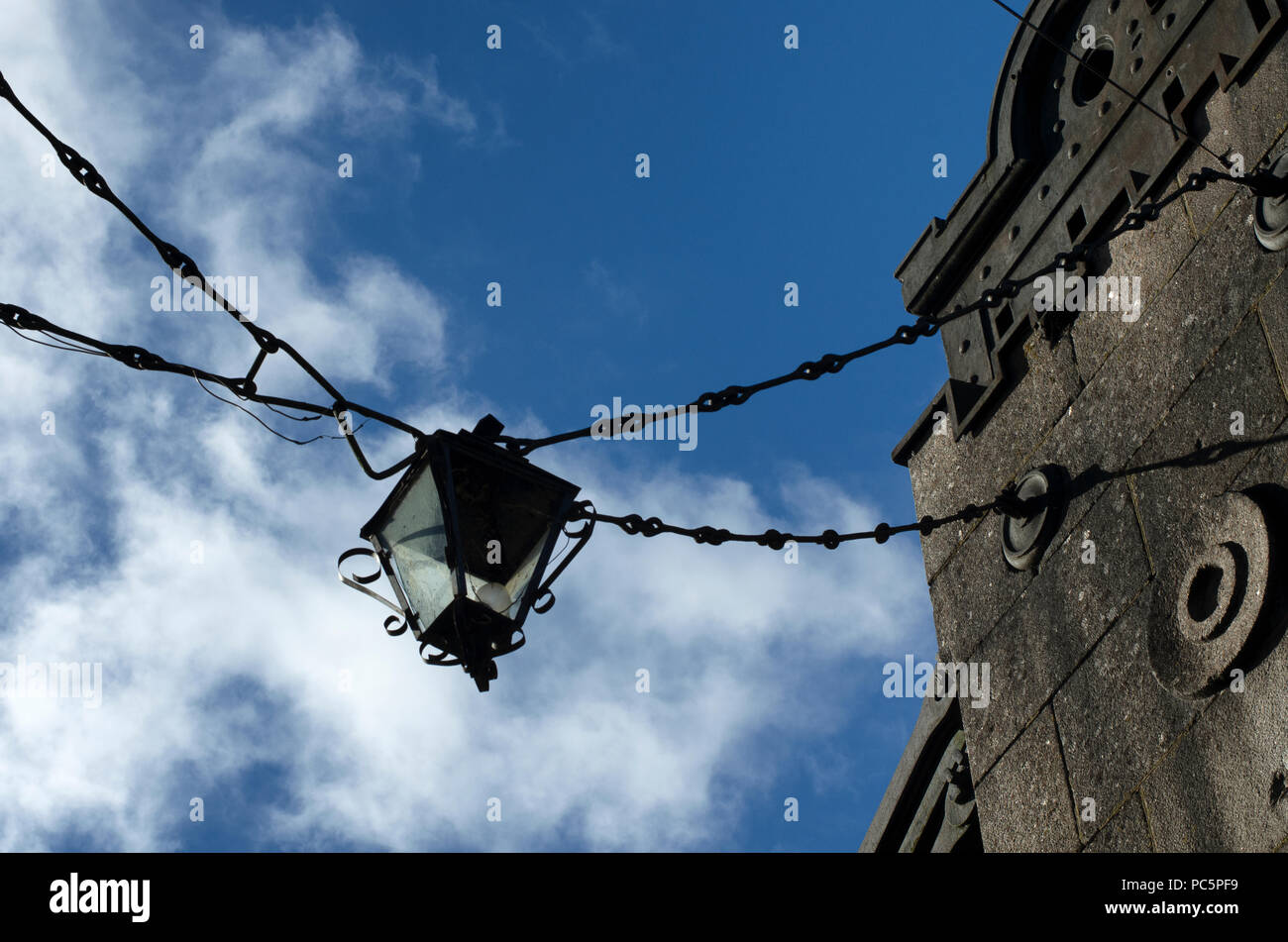 Hanging old lantern on the chains of the bridge support in the ...