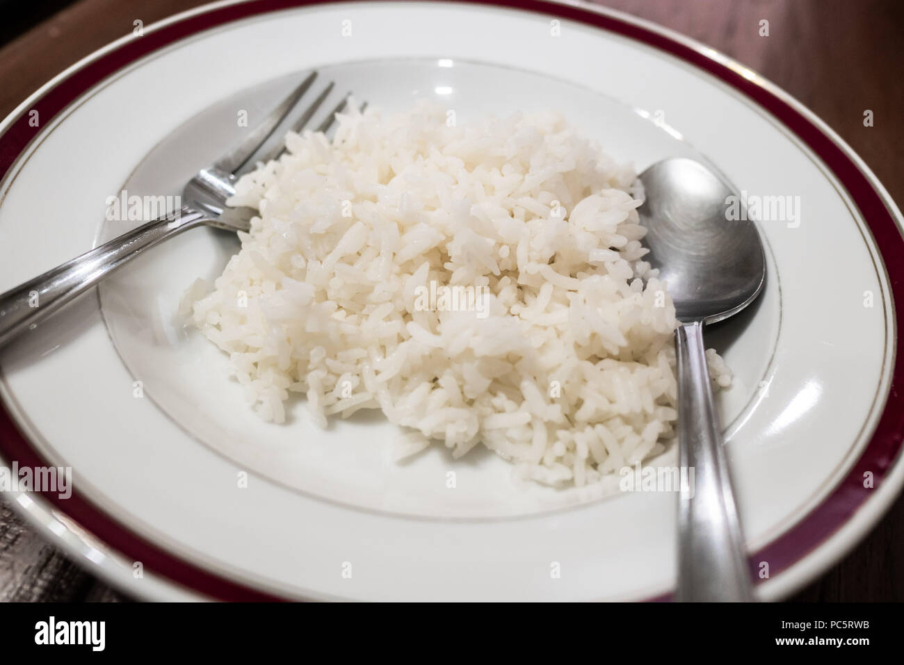 White Jasmine Rice in dish with spoon and fork Stock Photo - Alamy