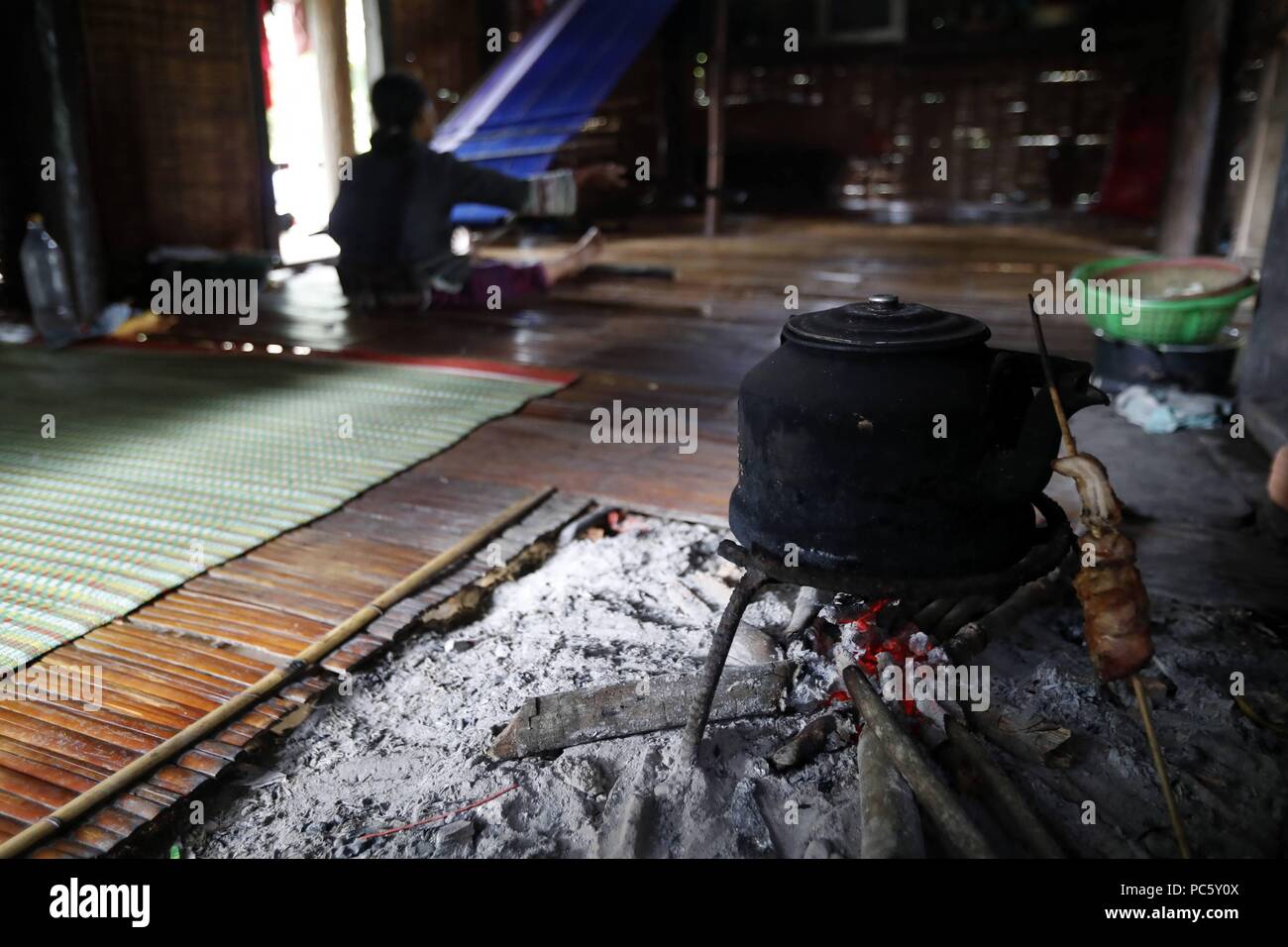Bahnar (Ba Na) ethnic group. Woman weaving silk at wooden loom. Kon Tum ...