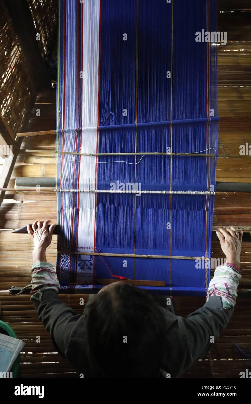 Bahnar (Ba Na) ethnic group. Woman weaving silk at wooden loom. Kon Tum ...