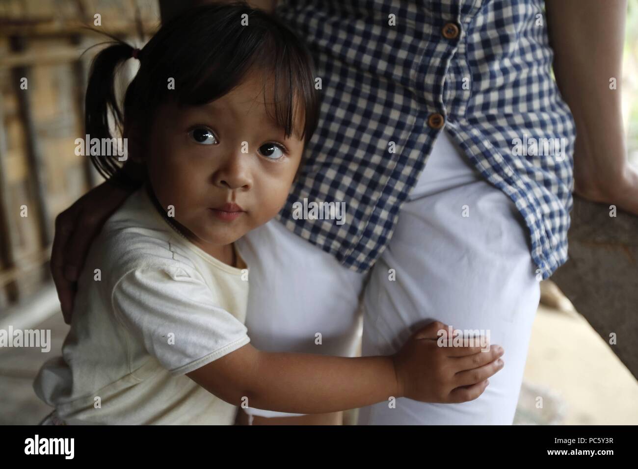 Bahnar (Ba Na) ethnic group. A woman and her daughter inside their ...