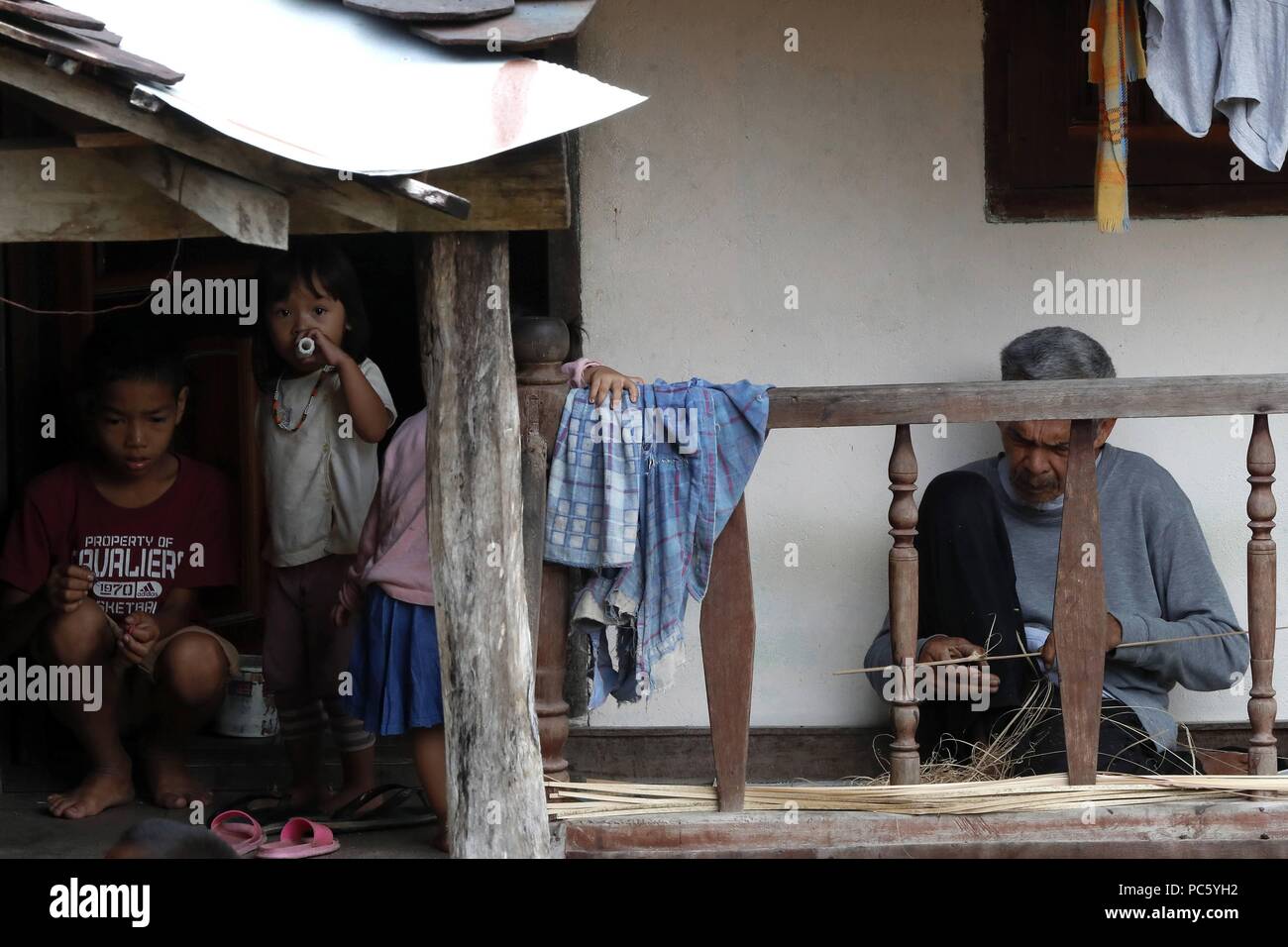 Bahnar (Ba Na) ethnic group. Old man using draw on wood. Kon Tum ...