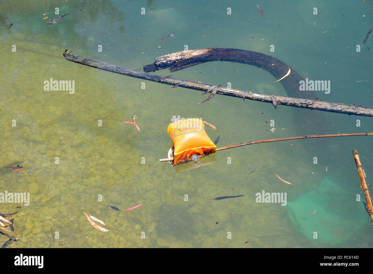 Plastic waste floats in the water at Alumot Dam. A dam on the Southern ...