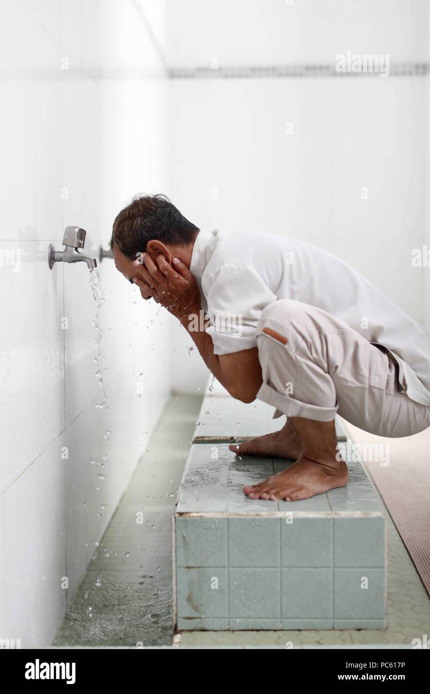 Masjid Al Rahim Mosque. Ritual purity in Islam. Muslim performing Wudu ...