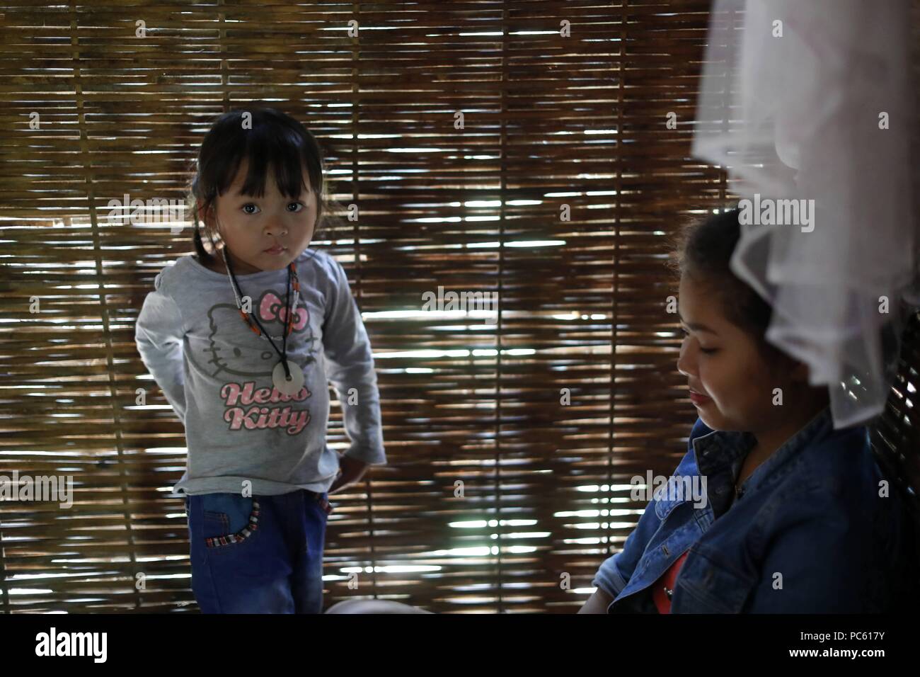 Bahnar (Ba Na) ethnic group. A woman and her daughter inside their ...