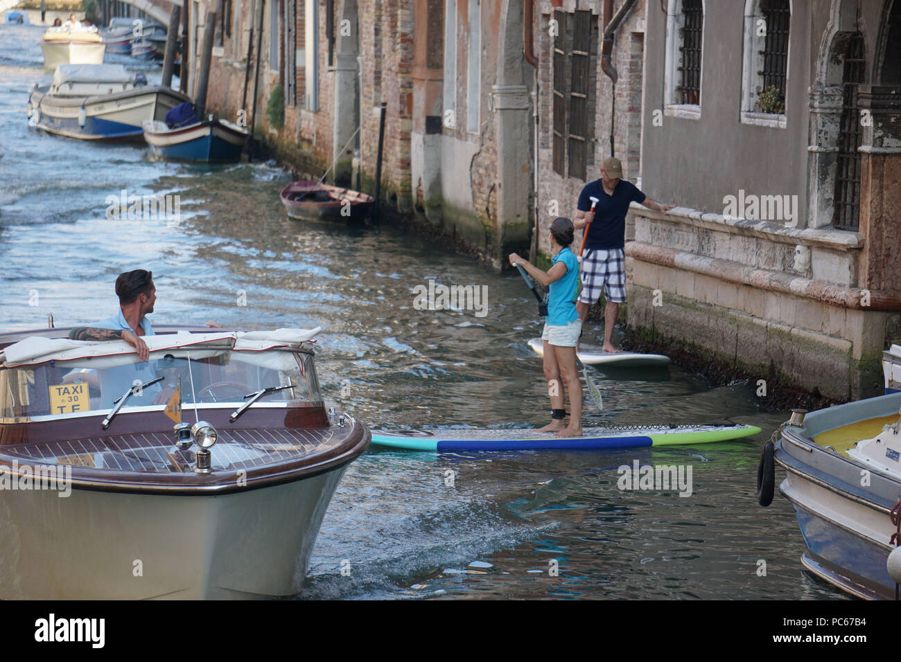Venice, Italy. 31st July, 2018. Some tourists sail aboard surf boards ...