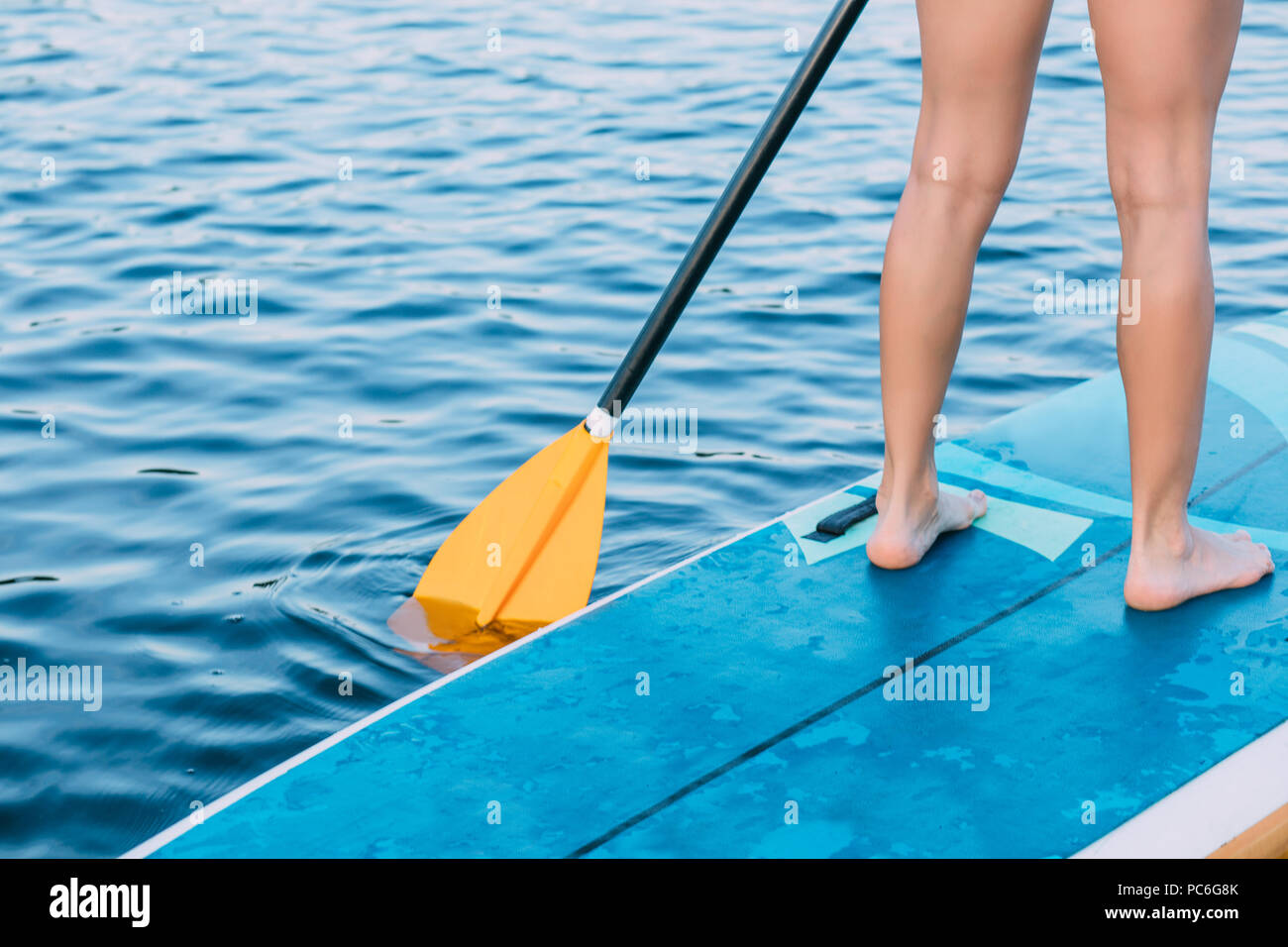 woman on paddle board in sea Stock Photo - Alamy