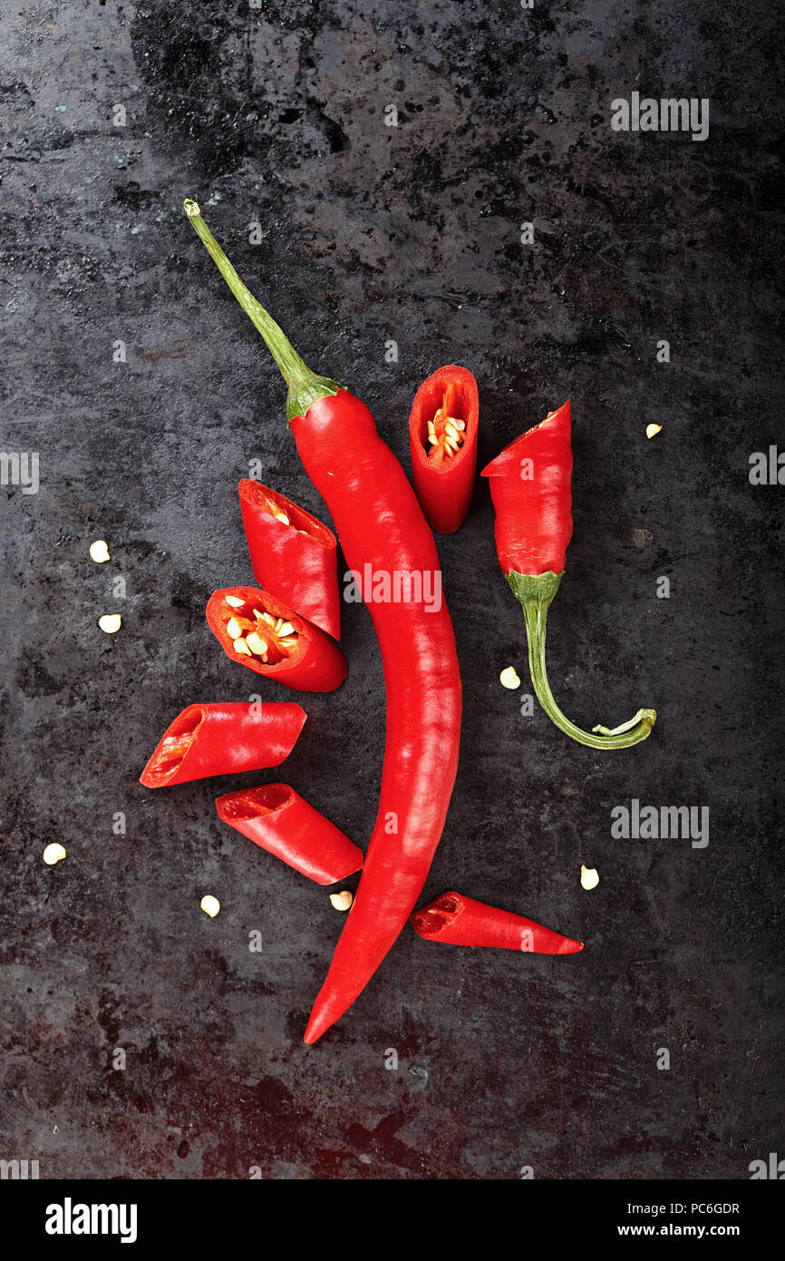 hot pepper cut on a black background, composition of pepper, slices and ...