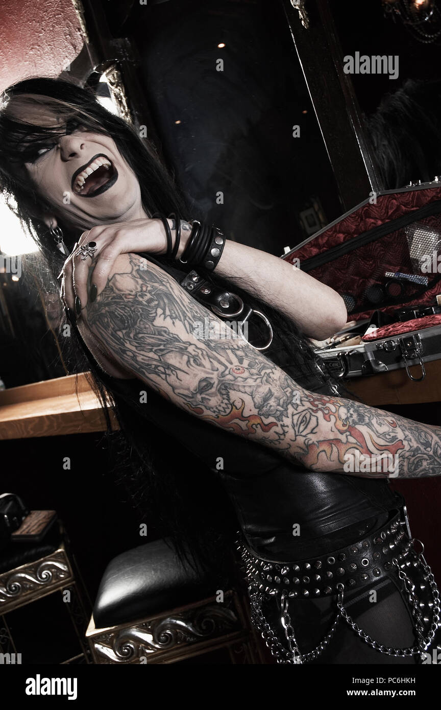 A gothic man laughs wildly as he gets ready Stock Photo - Alamy