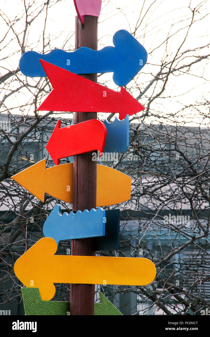 Colorful signs in the shape of an arrow on the street Stock Photo - Alamy