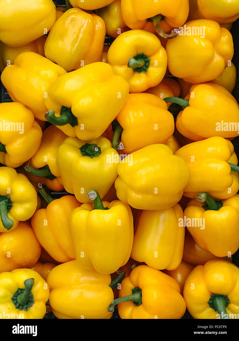 Pepper Top view Pattern with fresh yellow peppers on the market counter ...