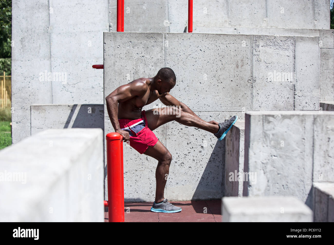 Athlete doing exercises at stadium Stock Photo - Alamy