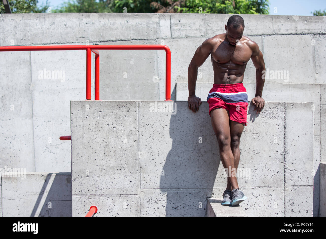 Athlete doing exercises at stadium Stock Photo - Alamy