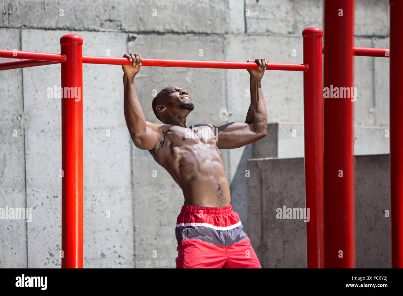 Athlete doing exercises at stadium Stock Photo - Alamy