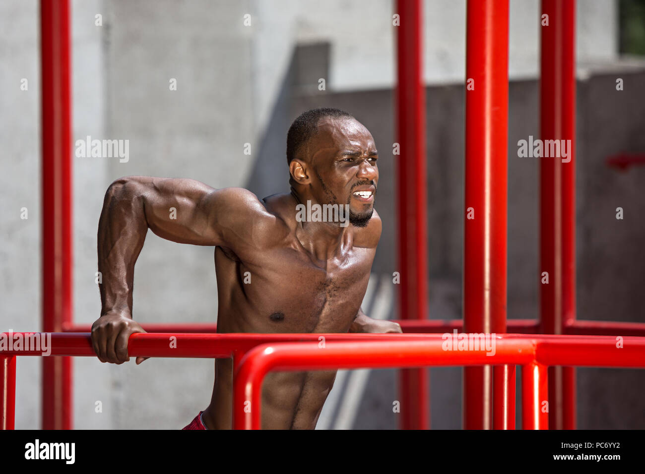 Athlete doing exercises at stadium Stock Photo - Alamy