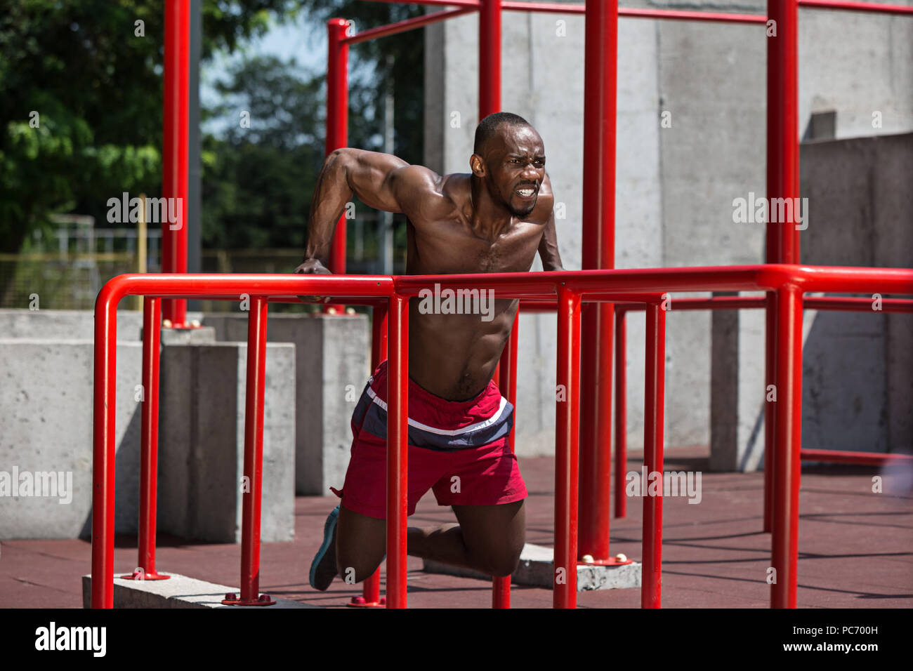 Athlete doing exercises at stadium Stock Photo - Alamy