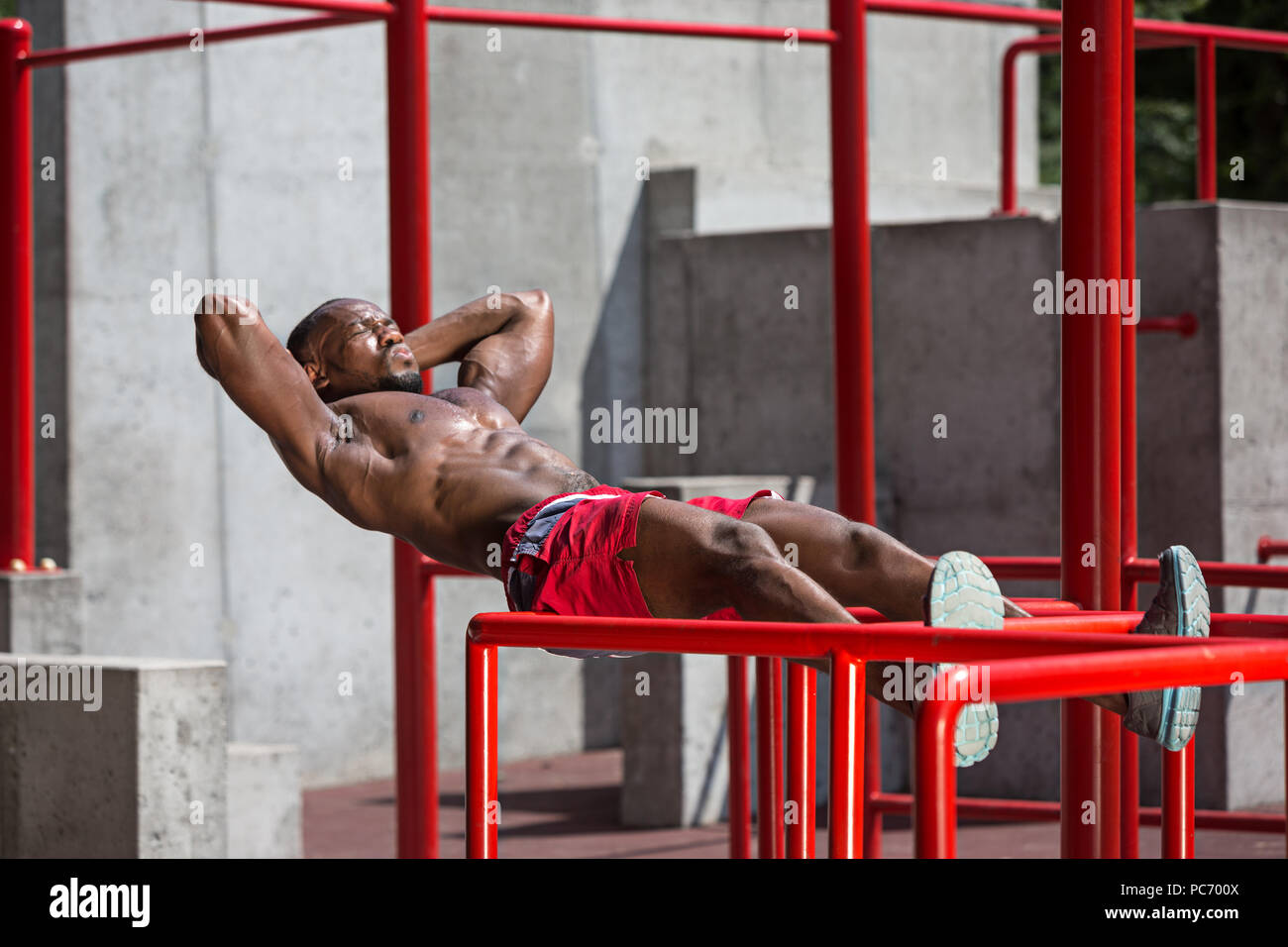 Athlete doing exercises at stadium Stock Photo - Alamy