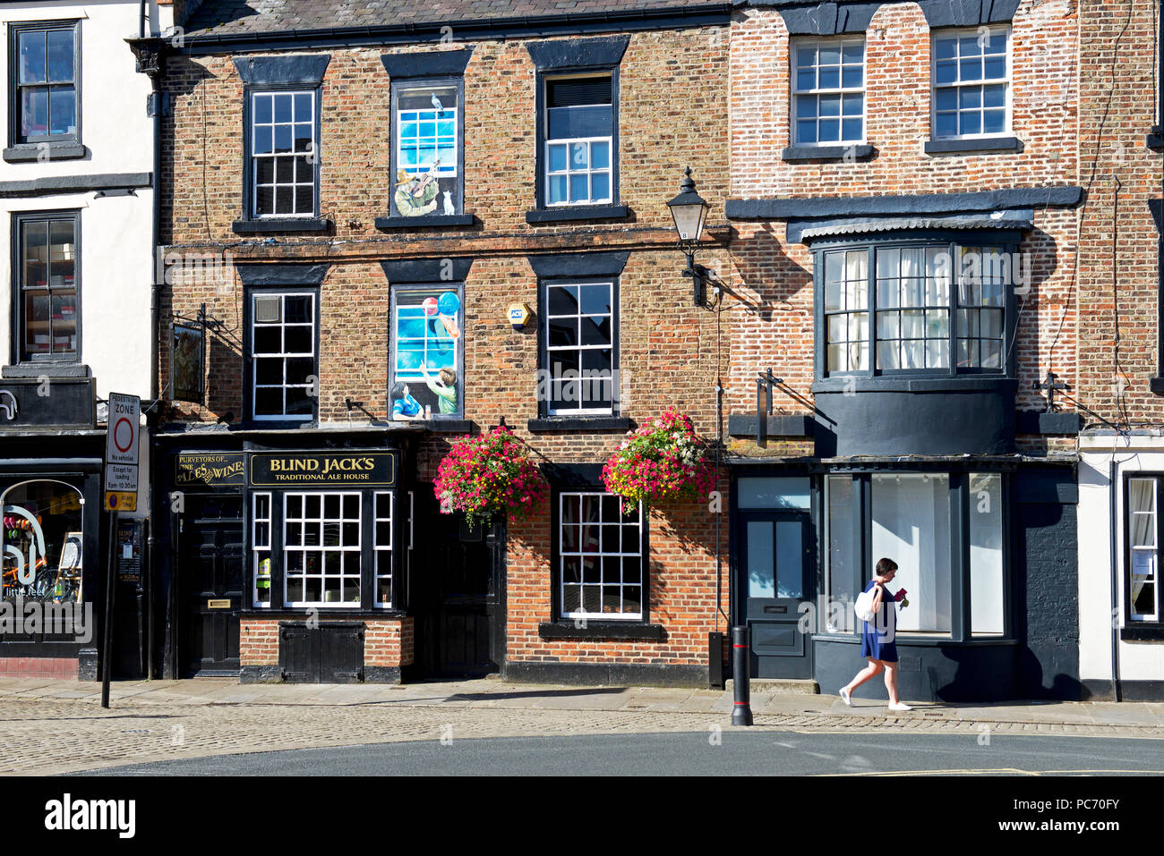 Woman walking past Blind Jack's pub, Knaresborough, North Yorkshire ...