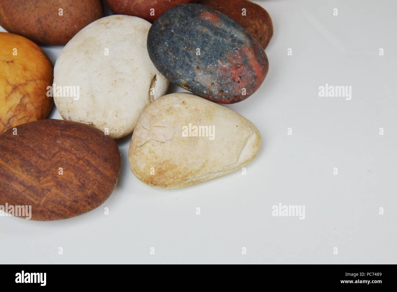 stone on white wooden board Stock Photo - Alamy
