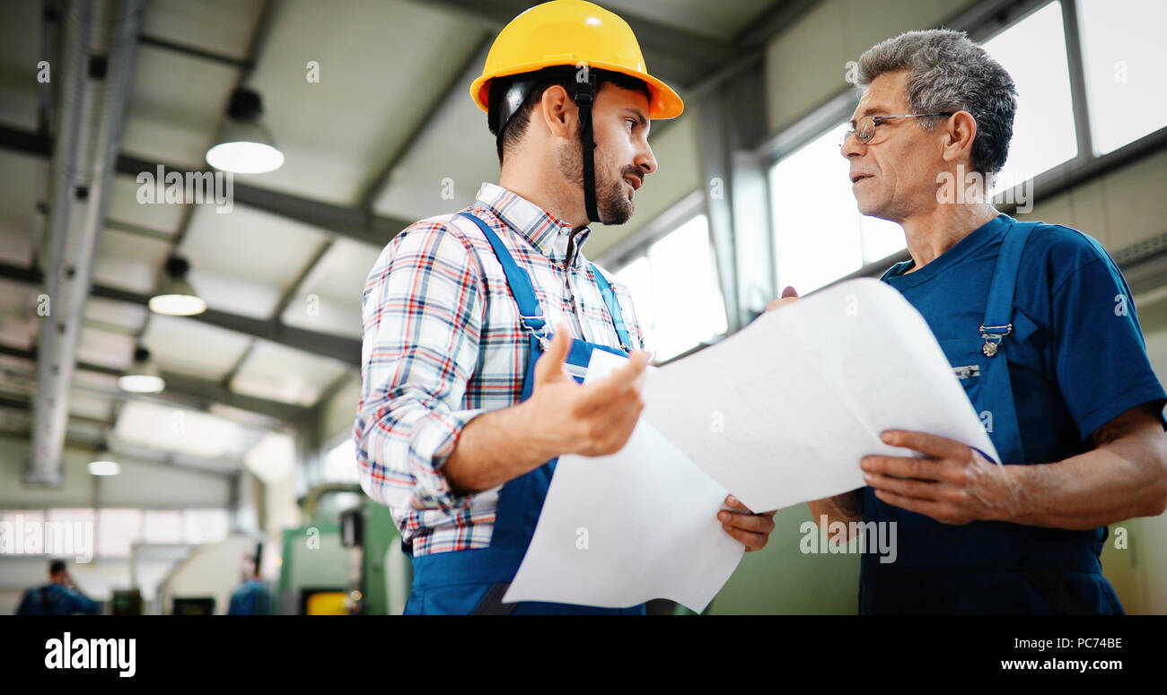 Team Of Engineers Having Discussion In Factory Stock Photo - Alamy