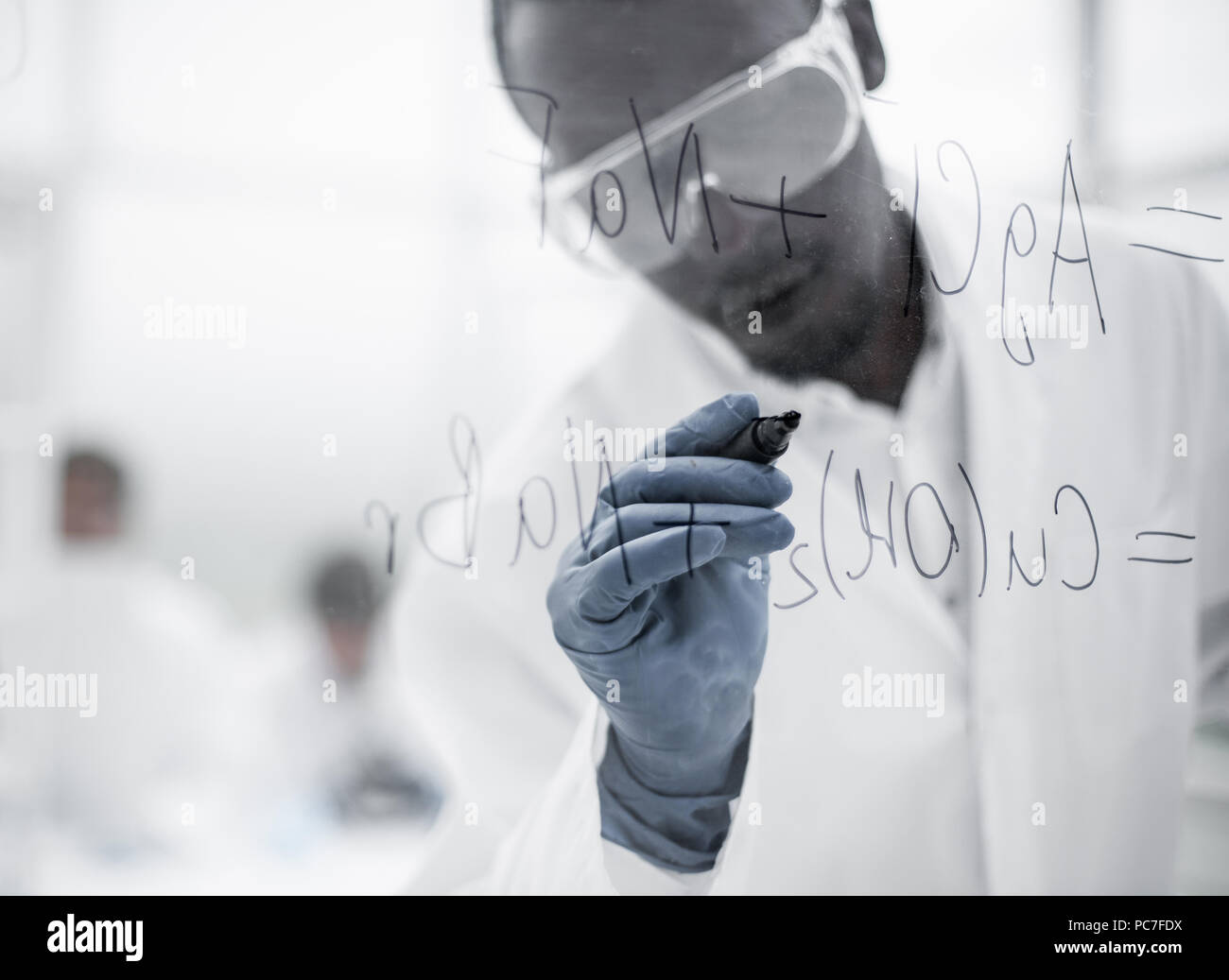 scientist writing chemical formula on a glass Board Stock Photo - Alamy