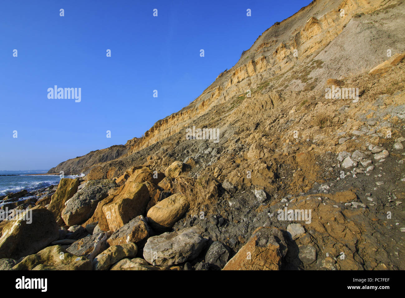 Steep headland showing recent rockfalls onto beach with Oxford Clay at ...