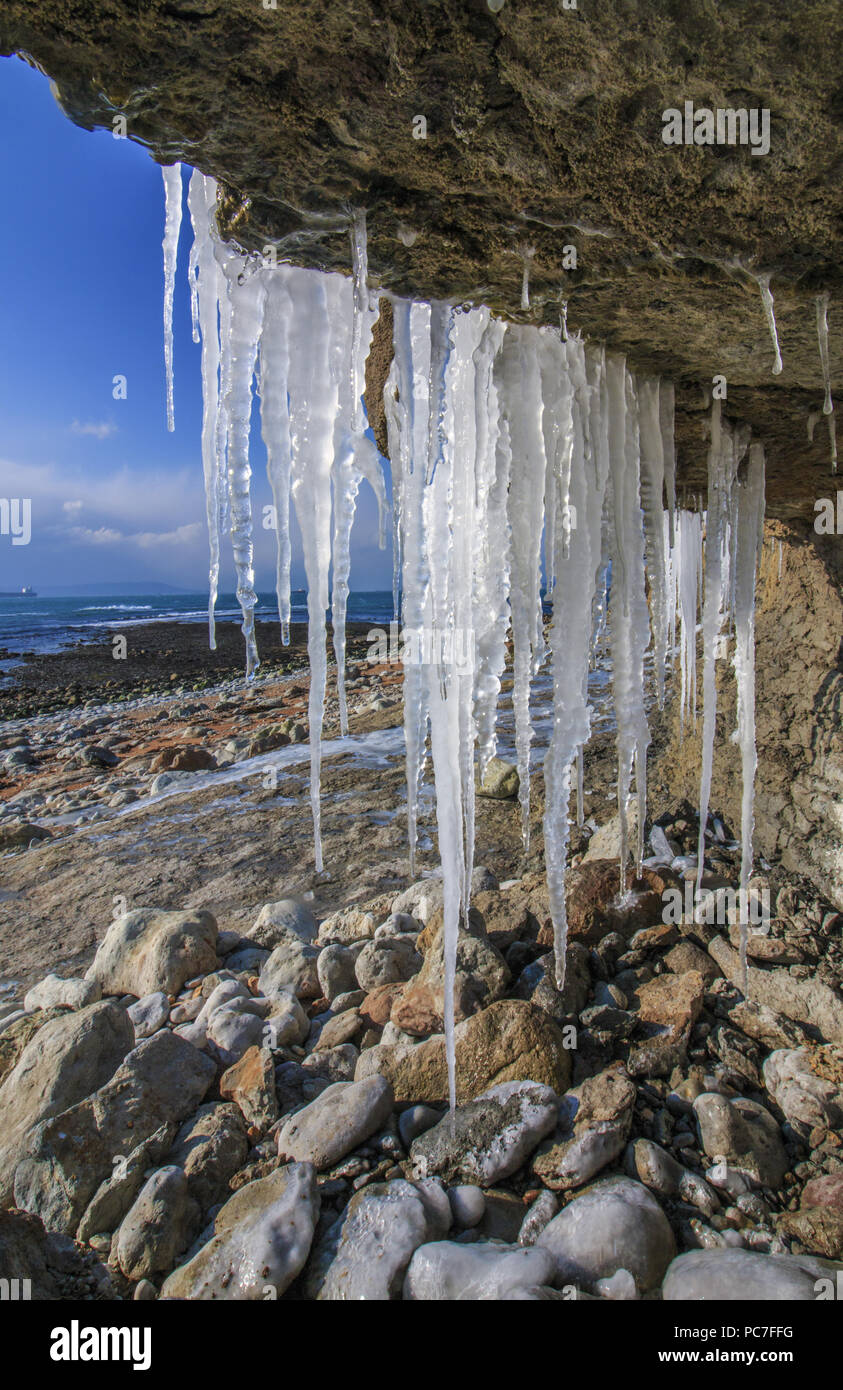 Icicles hanging from frozen cliff waterfalls Osmington Mills, Dorset ...