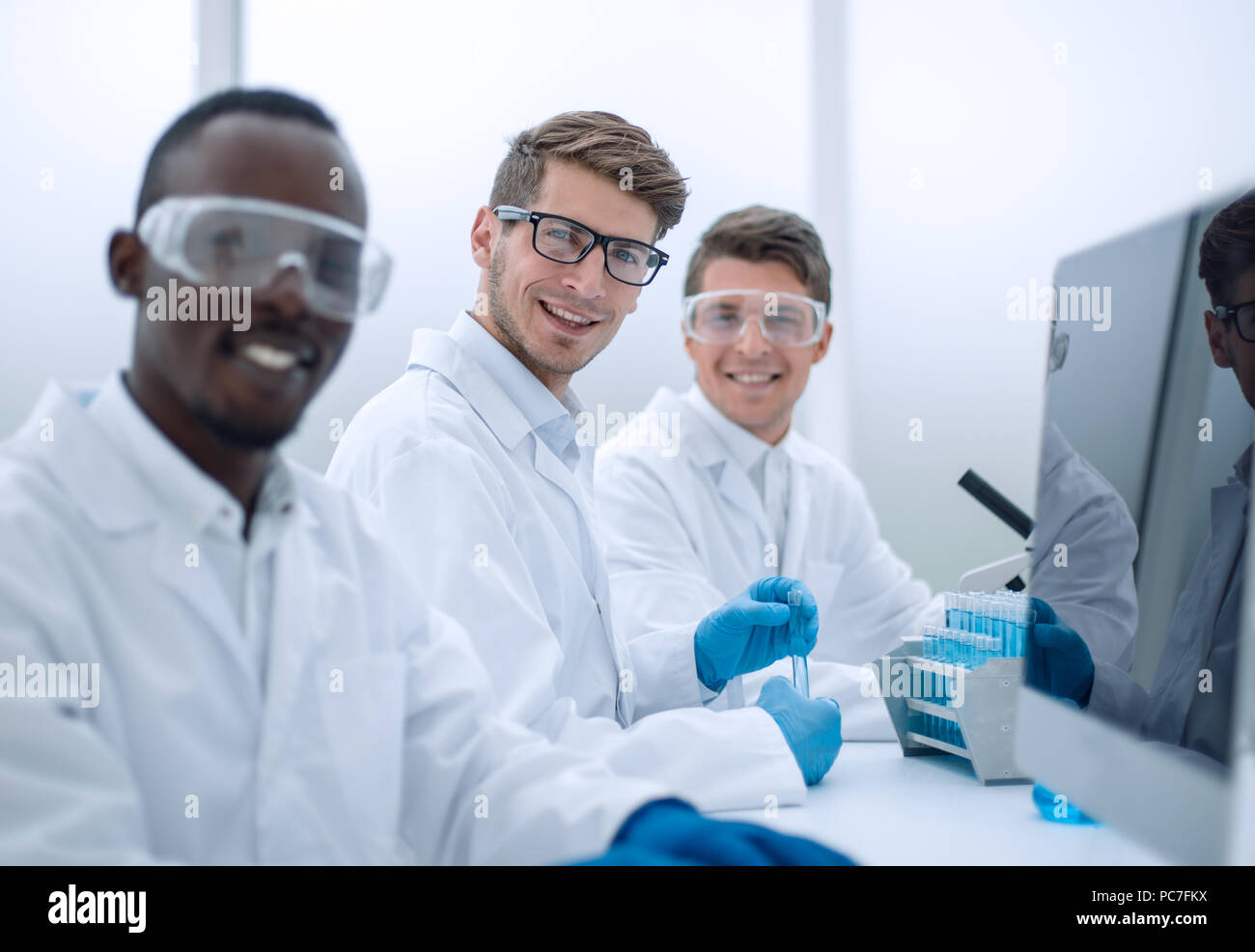 successful group of scientists sitting at their Desk Stock Photo - Alamy