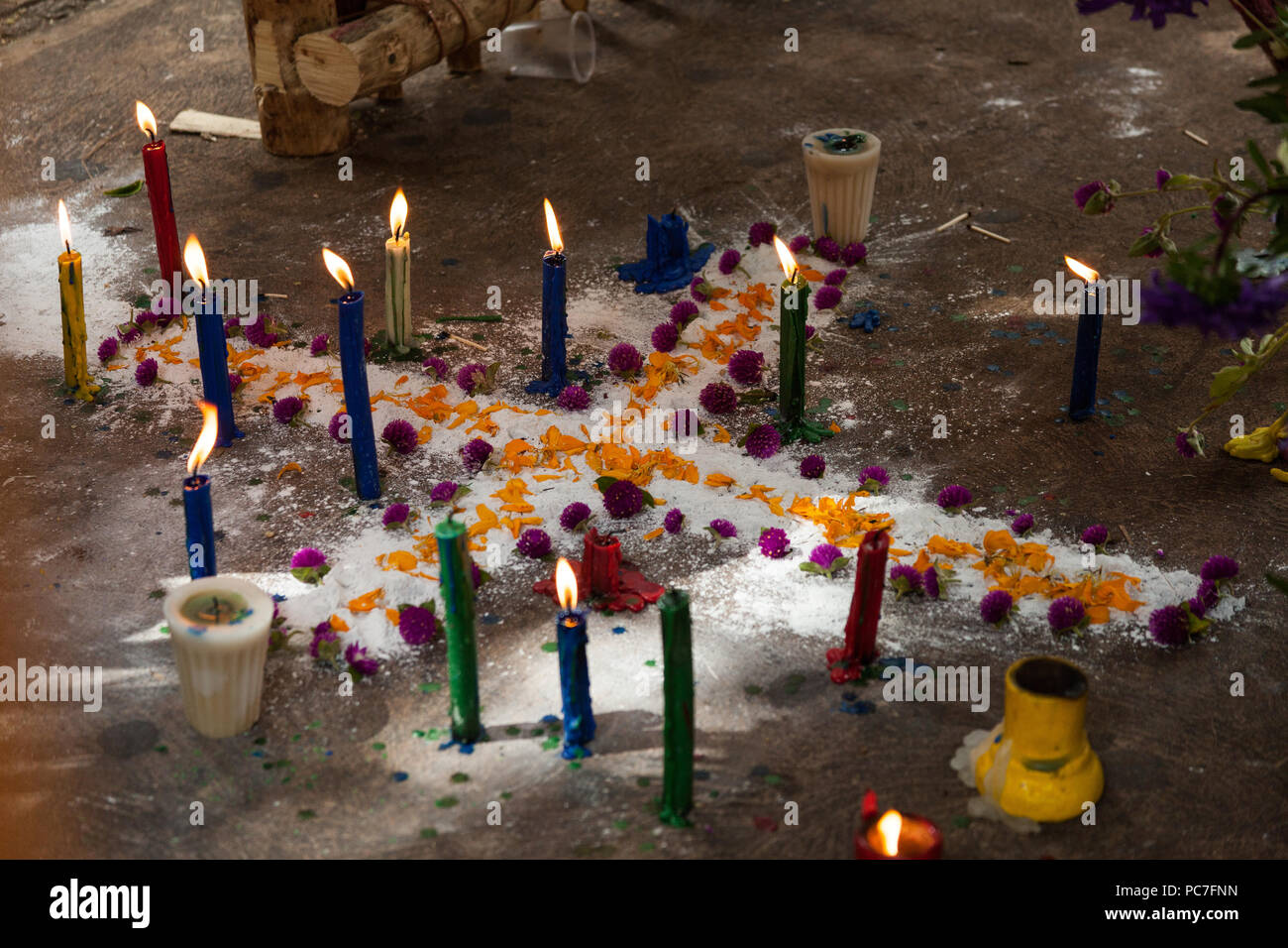 Salt and flower cross sorrounded by candles illuminates the path for ...