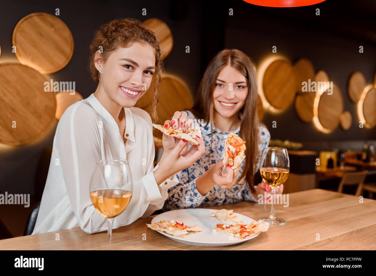 Beautiful women sitting table tasty hi-res stock photography and images ...