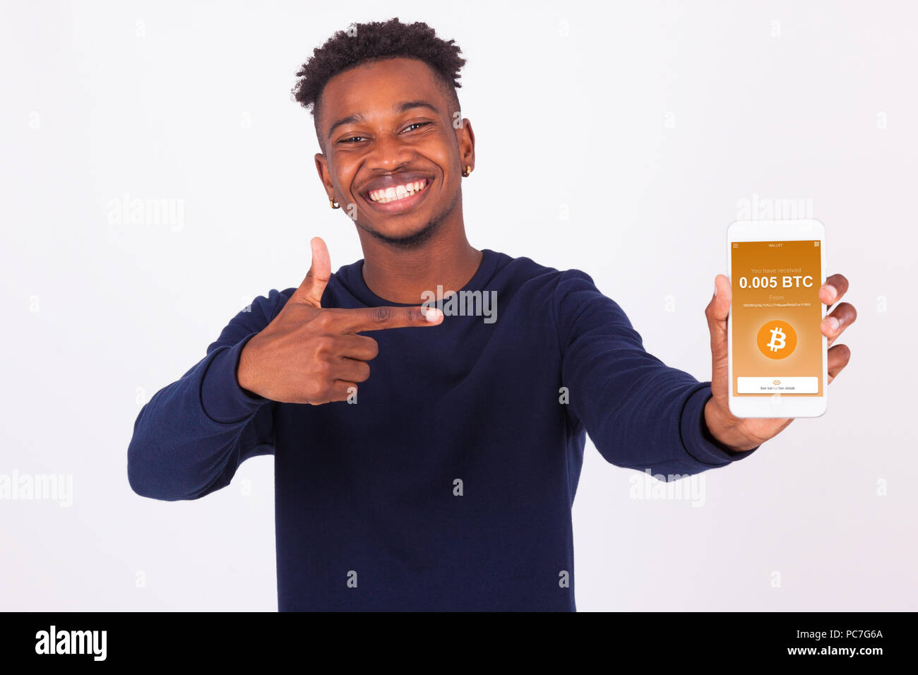 Young African American man pointing his smartphone screen showing a ...