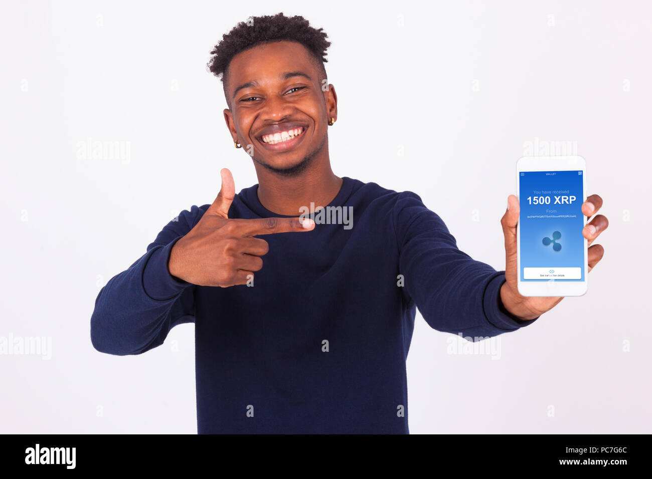 Young African American man pointing his smartphone screen showing a ...