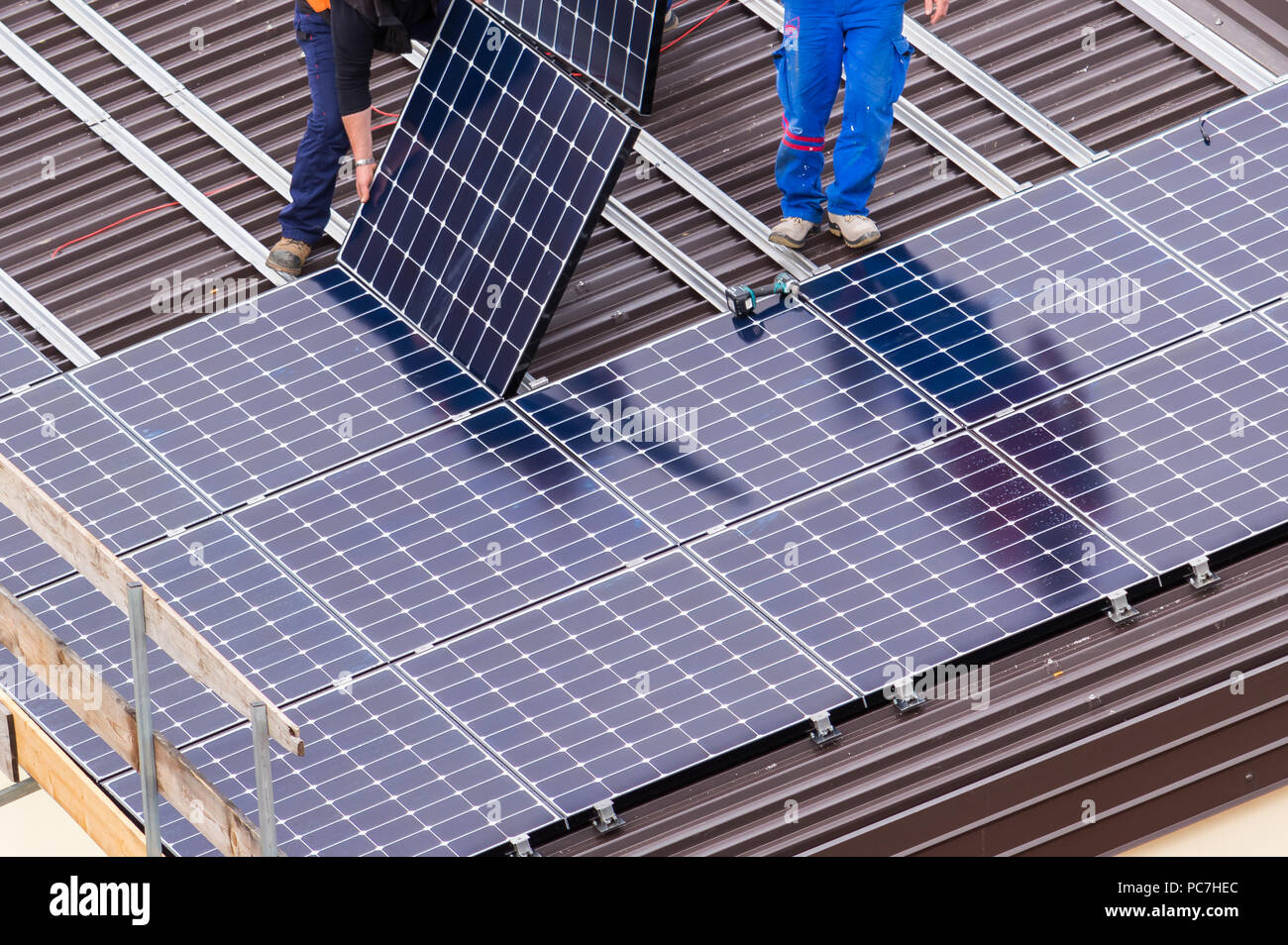 Installation of solar panels on a roof Stock Photo - Alamy