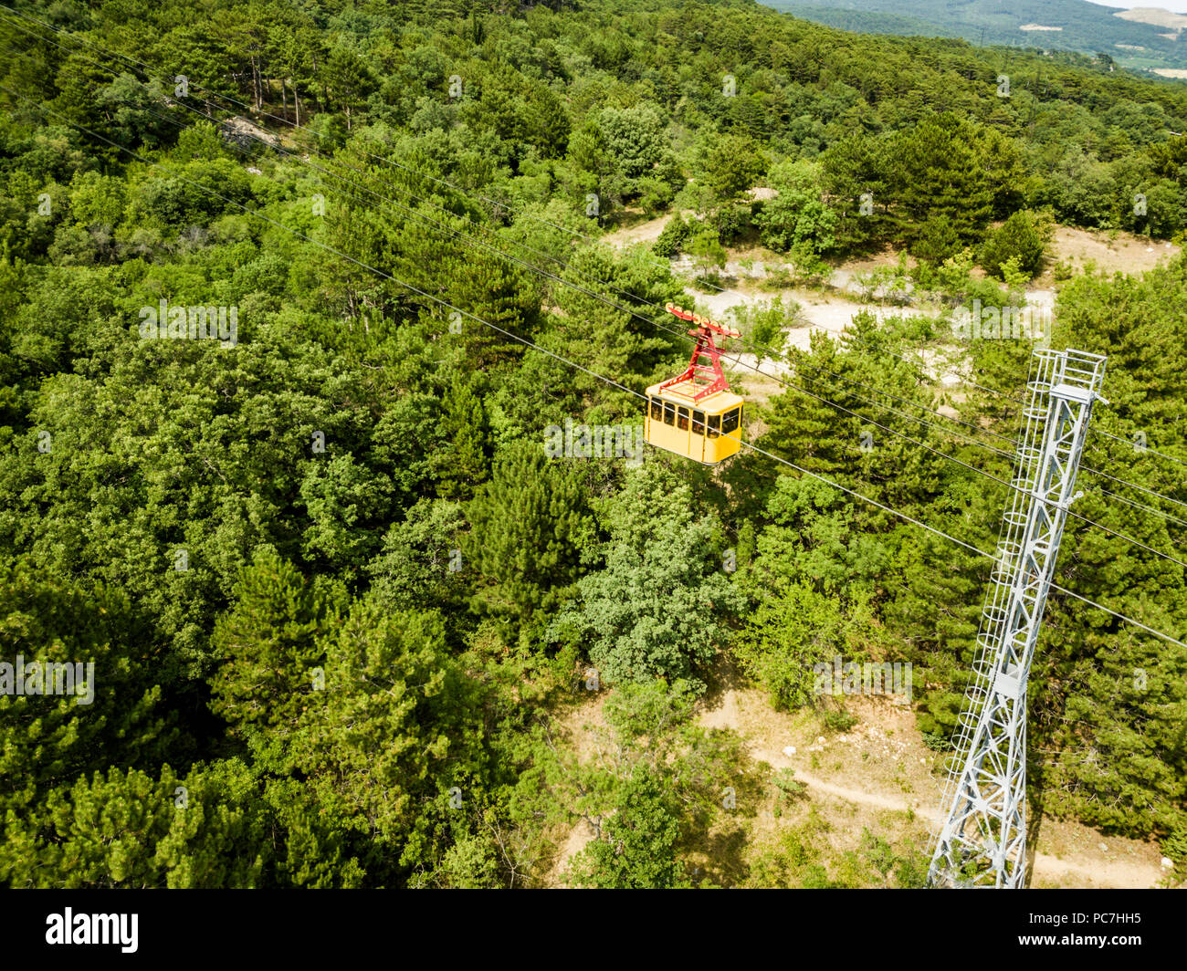 cableway cabin aerial view moving over the forest trees and the ...