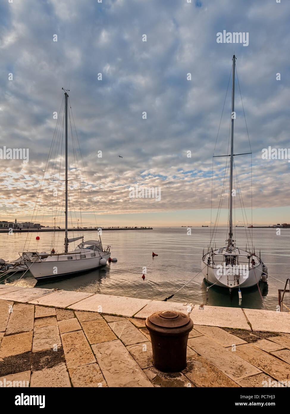 Pleasure boats moor in harbor with bollard Stock Photo - Alamy