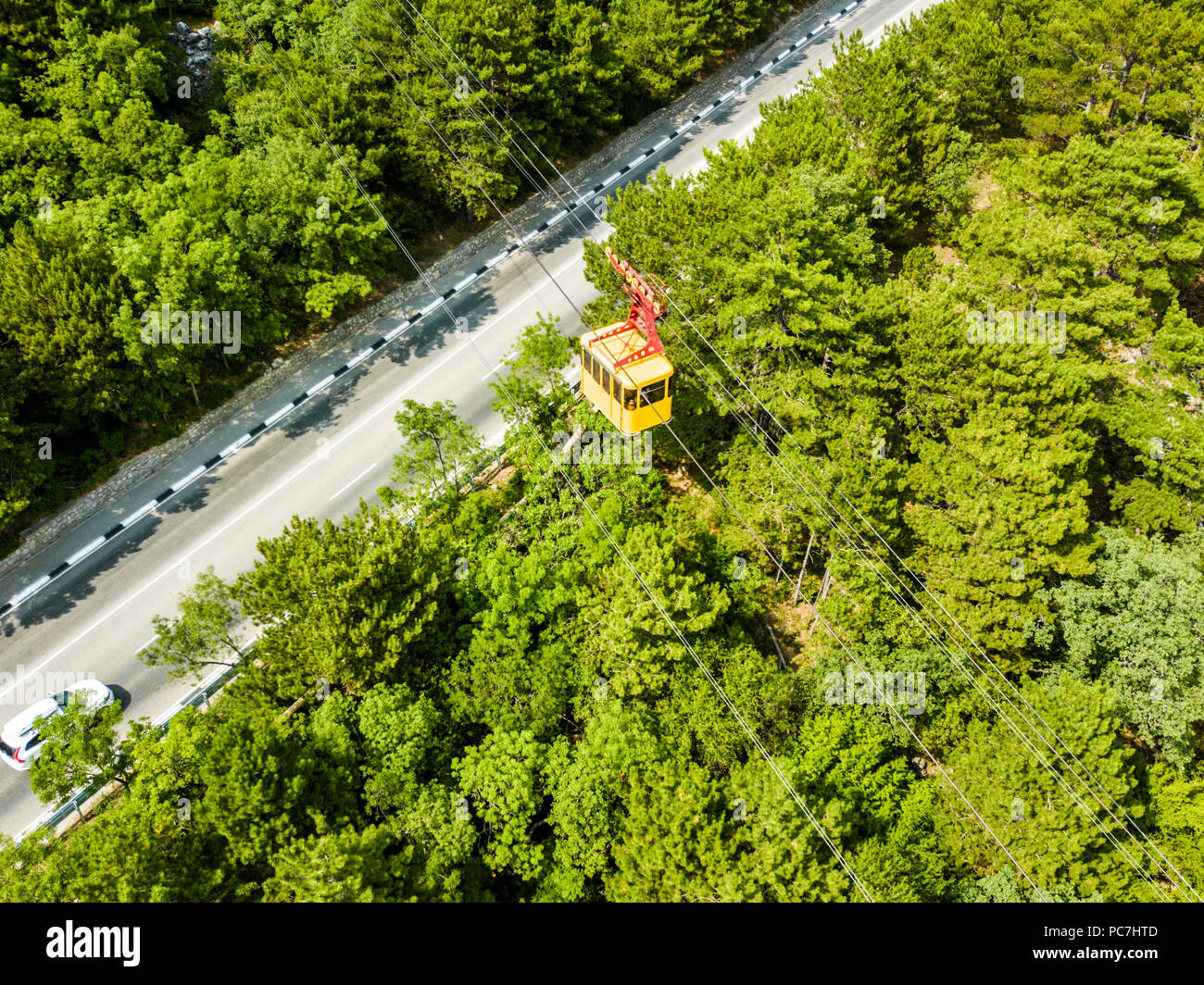 cableway cabin aerial view moving over the forest trees and the ...