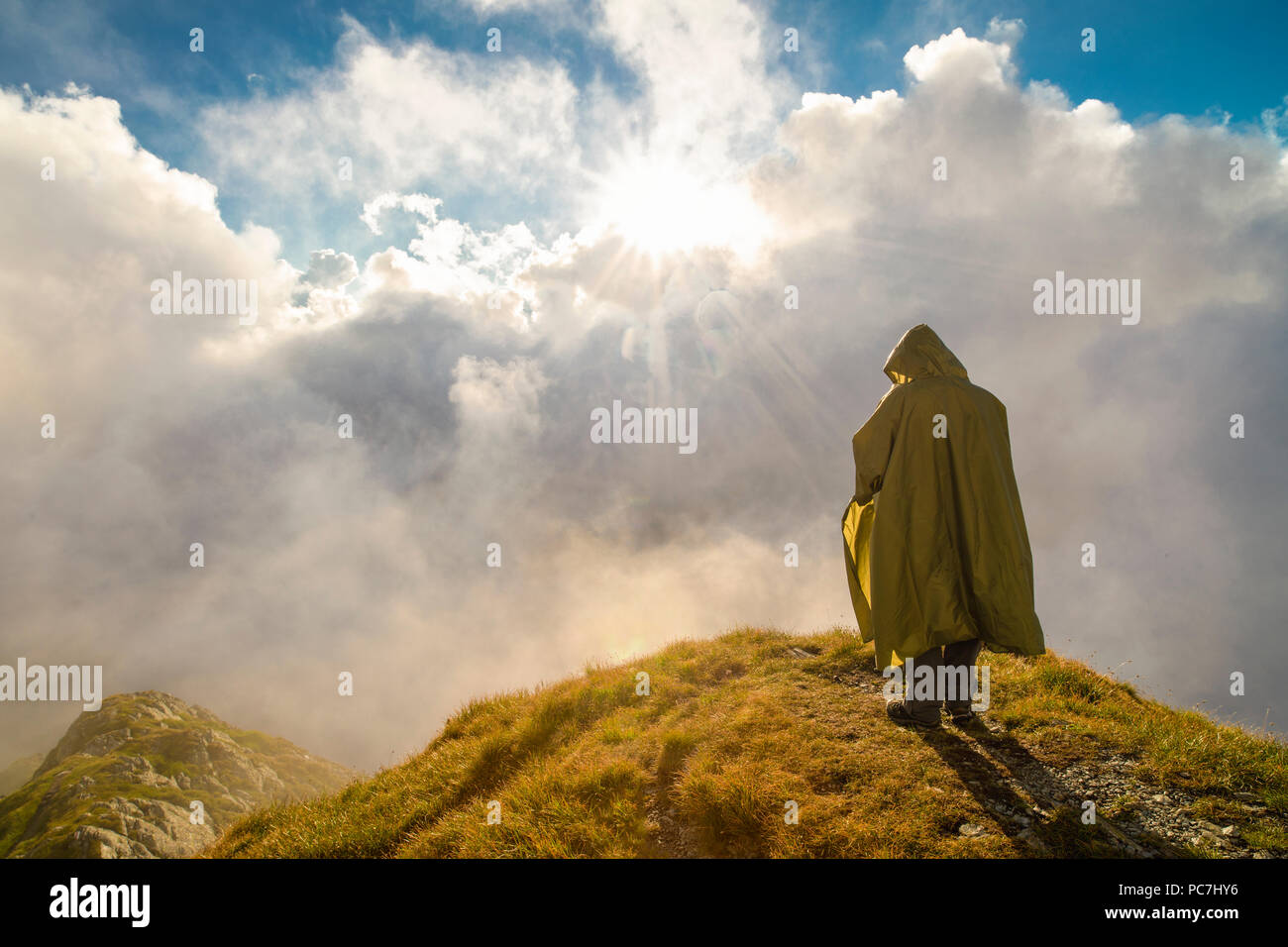 tourist on the mountain with a raincoat Stock Photo - Alamy